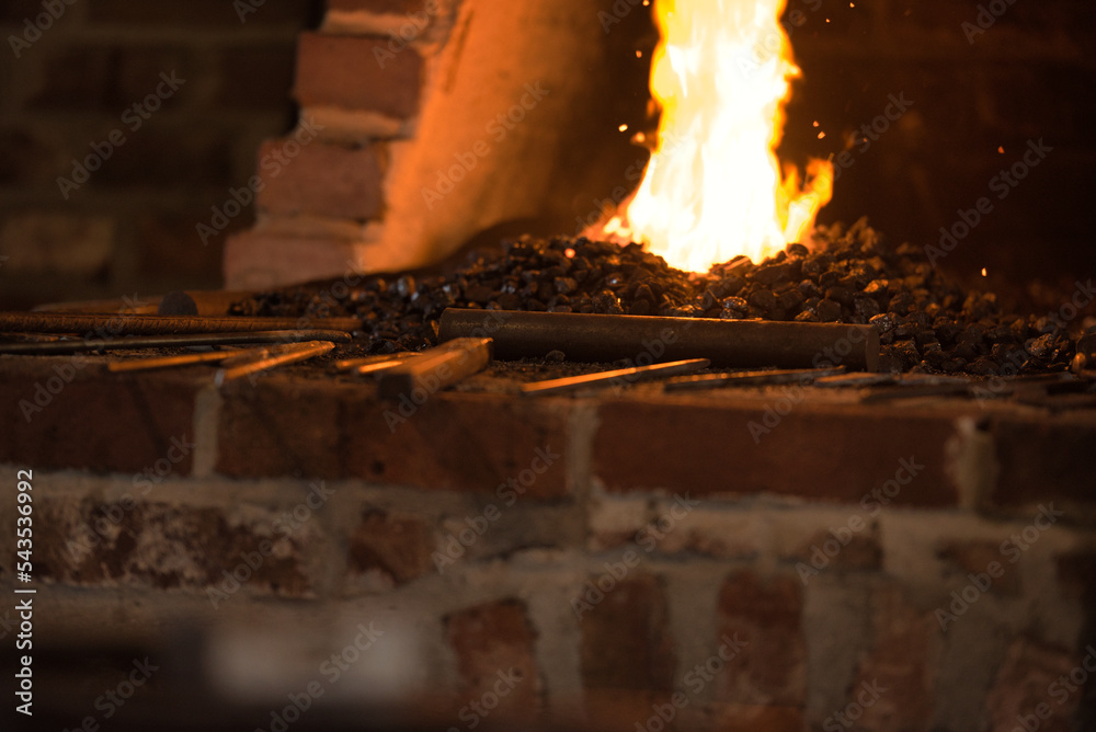 Fire for forging in a brick fireplace with coal and tools Stock Photo ...