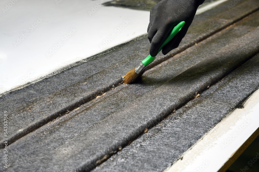 Installation of fiberglass: worker manually makes a component in glass ...