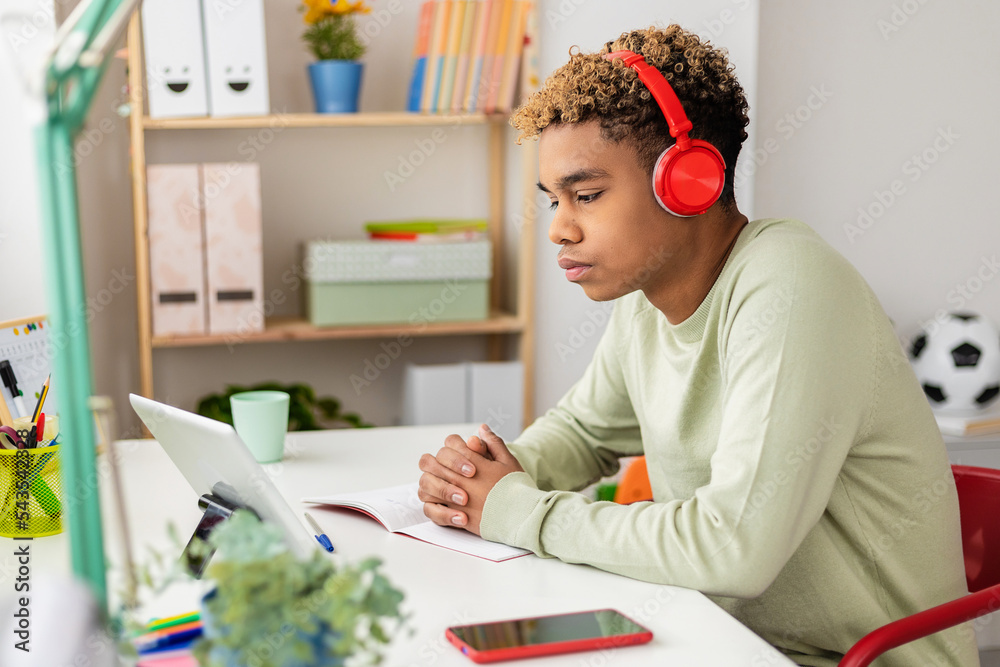 Concentrated young hispanic latin man learning language watching online ...