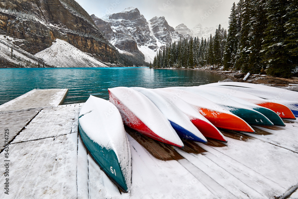 Snow covered canoes at Moraine Lake in Banff National Park Alberta ...