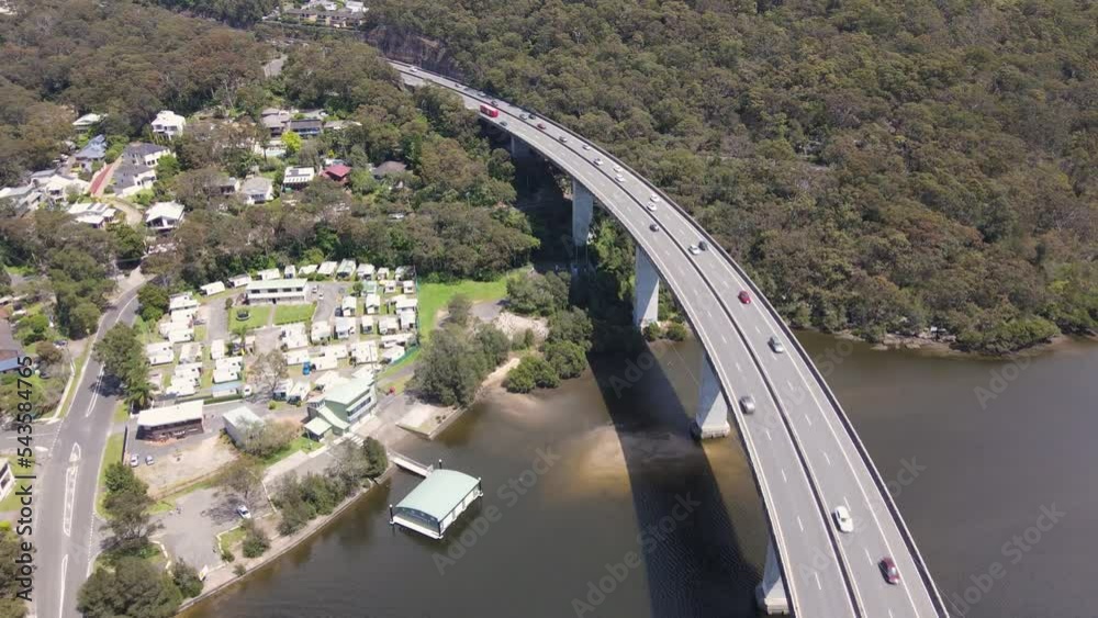 Aerial drone reverse pullback view of Woronora River Bridge across ...