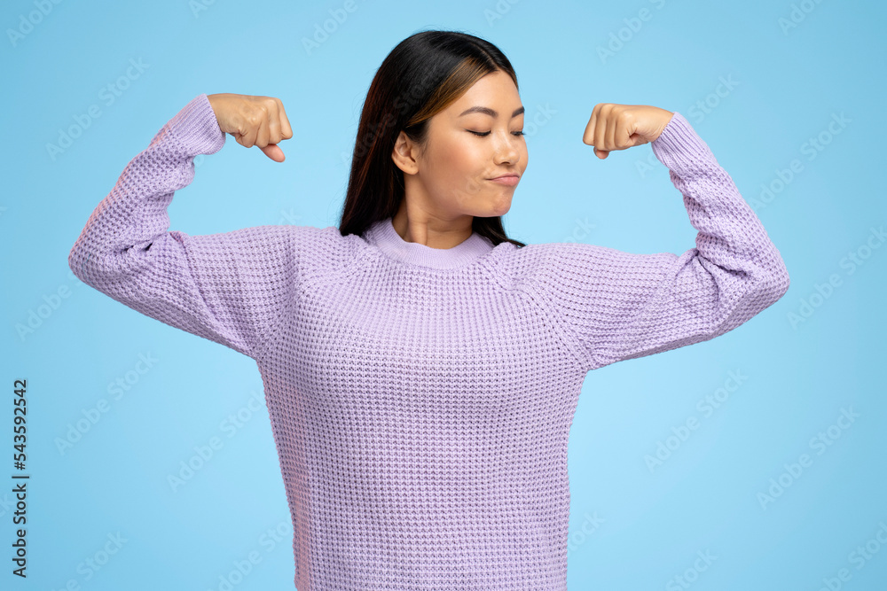 Woman raising arms showing biceps as metaphor of female power and ...