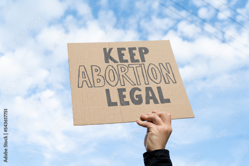 Female hand holding sign with slogan Keep Abortion Legal. Woman with ...