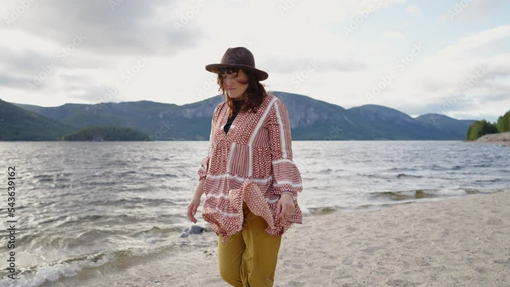 girl with a hat dressed in a boho style of European appearance,, walks ...