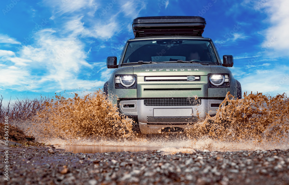 Rybachy, RUSSIA - May 30 2022: Off-roading New Land Rover Defender. The ...
