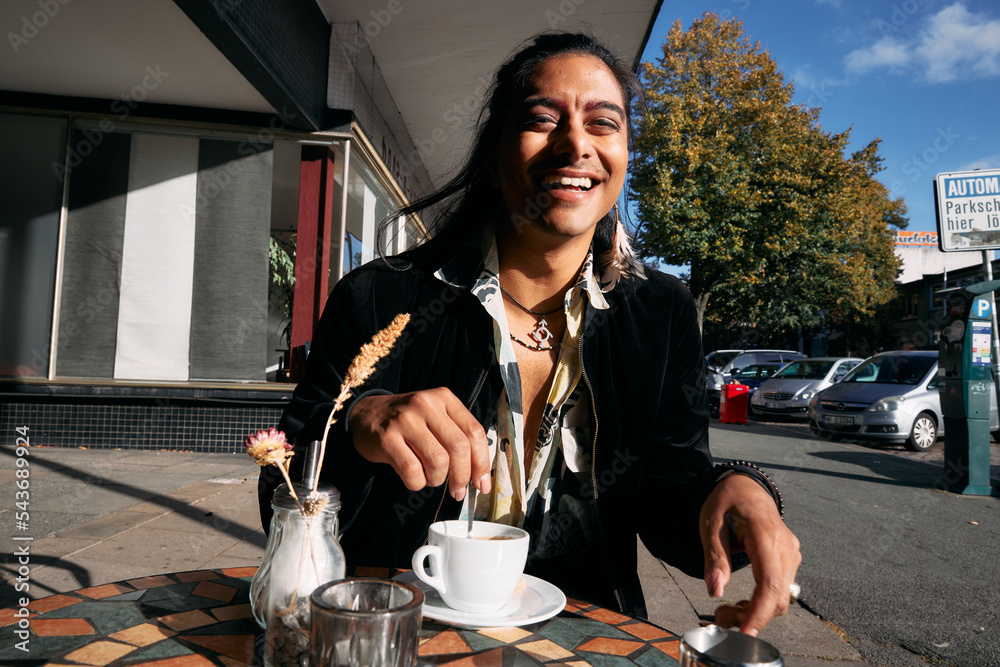 Gender fluid person at a cafe Stock Photo | Adobe Stock