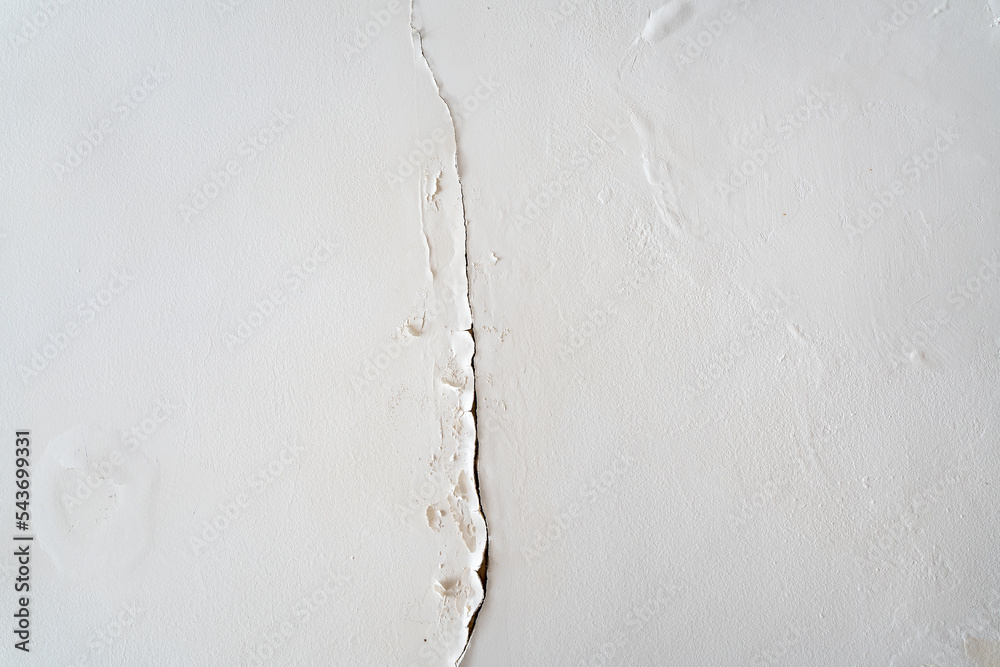 View of a roof and a crack with rain water seeping into the wall ...