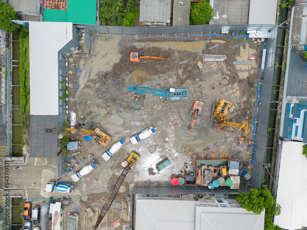 Aerial view of busy industrial under construction site workers working ...