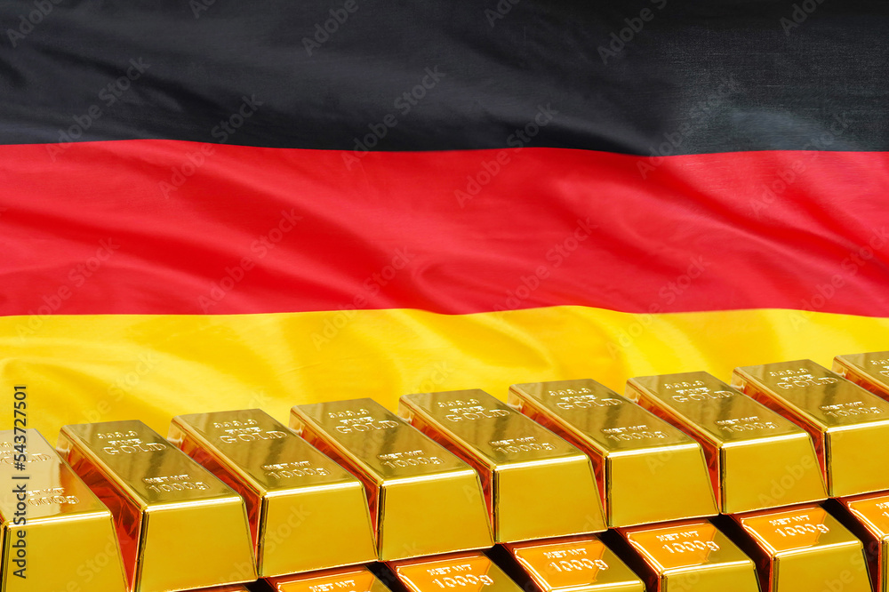Row of shining golden bullions on the Germany flag background. Business ...