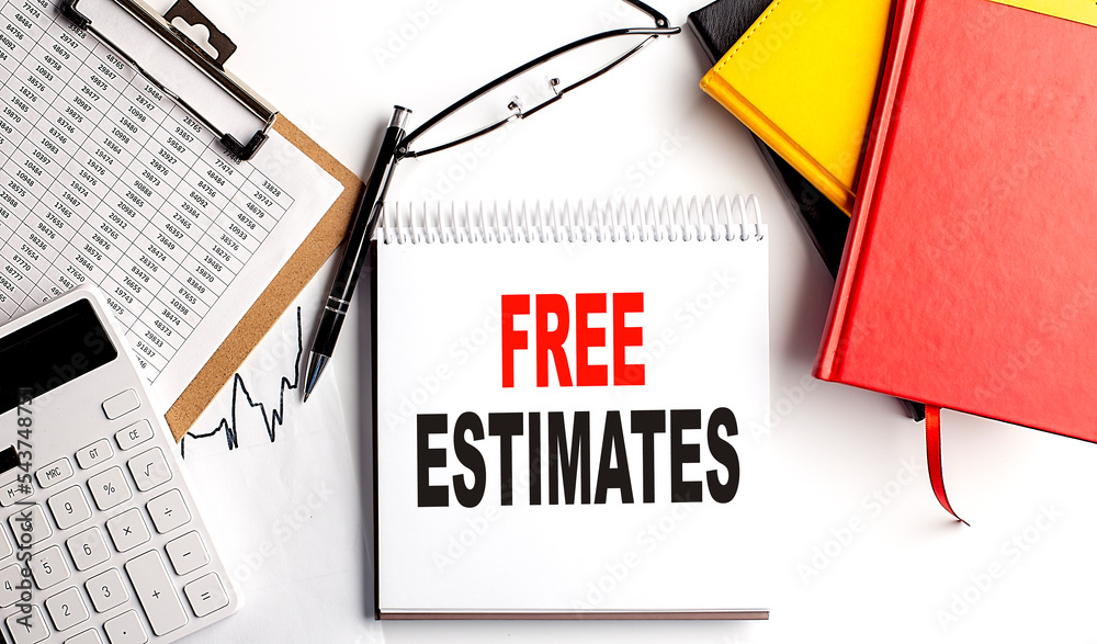 FREE ESTIMATES text on notebook with clipboard and calculator on white ...