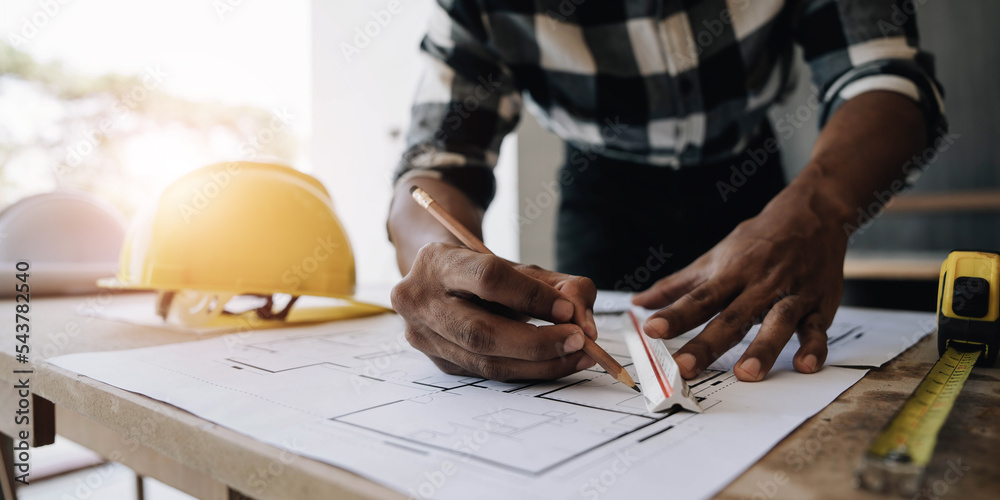 Image of engineer drawing a blue print design building or house, An ...