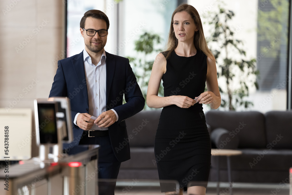Foto de Two young colleagues in formal wear hold access cards ...