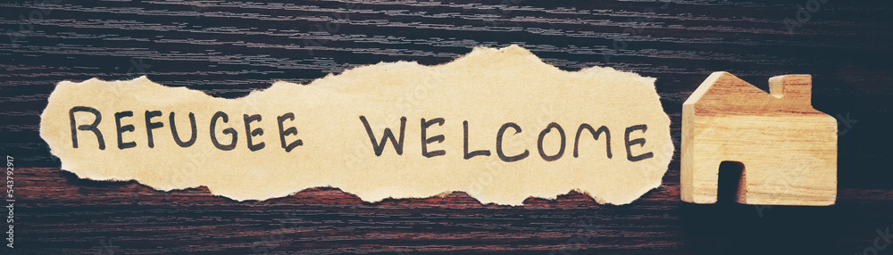pieces of paper with words Refugee Welcome message for help people ...