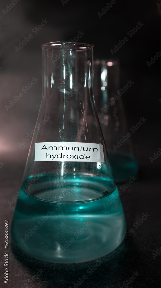 Ammonium hydroxide or ammonia solution 30% in glass flask with copy ...