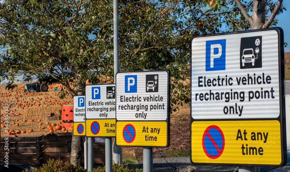 Electric vehicle charging point signs. A row of EV charging point ...