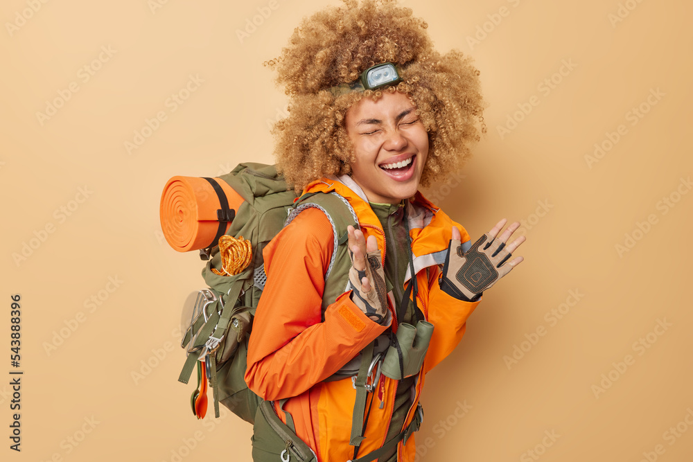 Female backpacker enjoys adventure time wears headlamp orange jacket ...