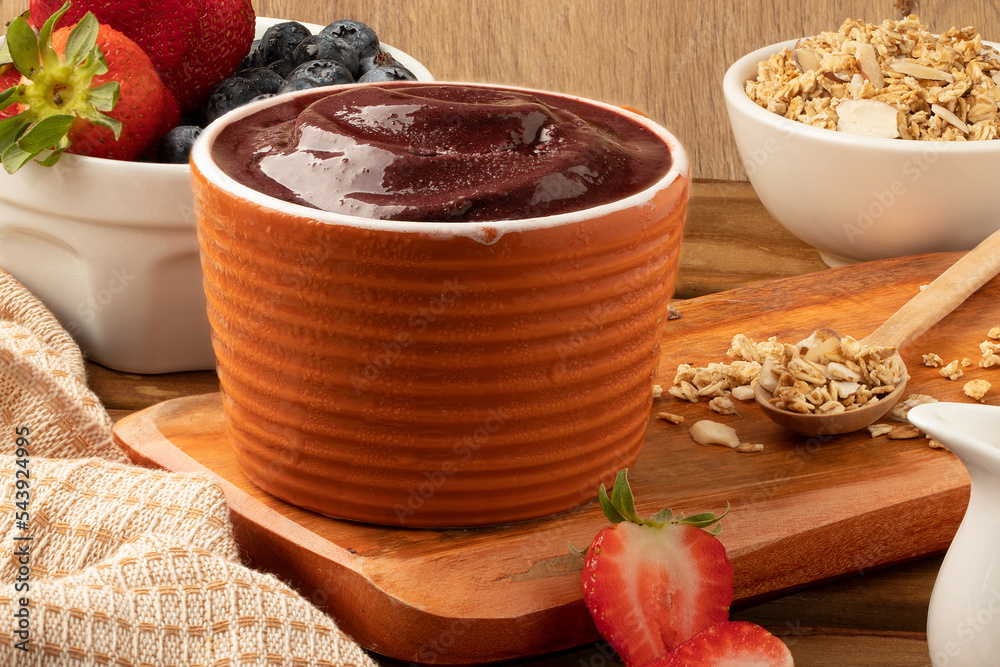 Traditional Brazilian açaí bowl with strawberry, blueberry and granola ...