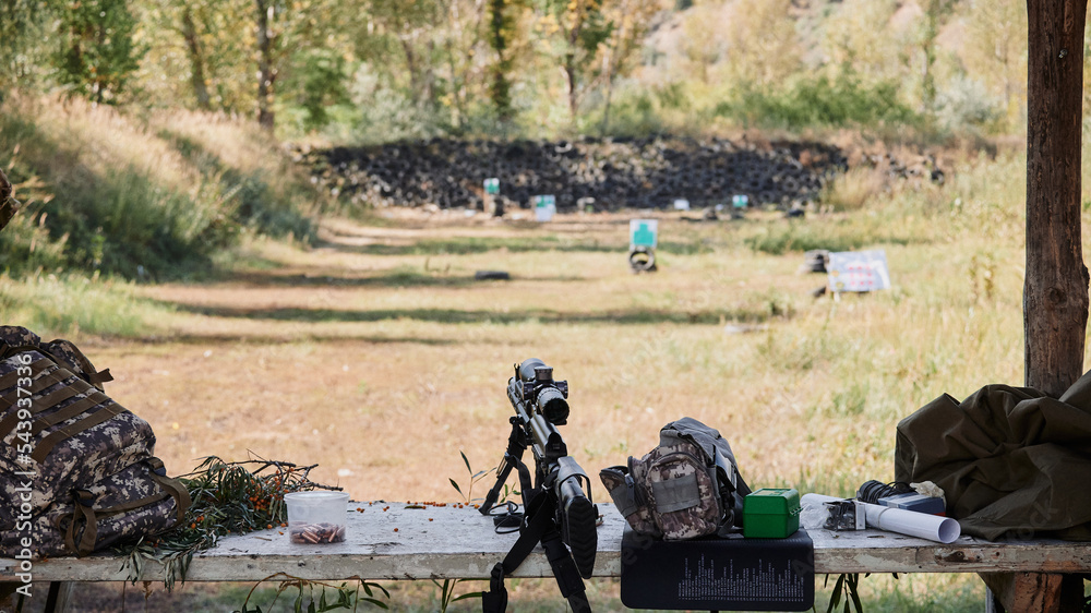 Kalashnikov assault rifle on the firing line of a shooting range with ...