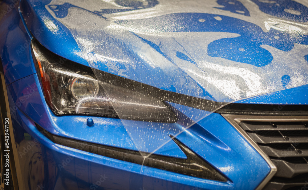 The process of installing PPF on the hood of the car.PPF is a ...