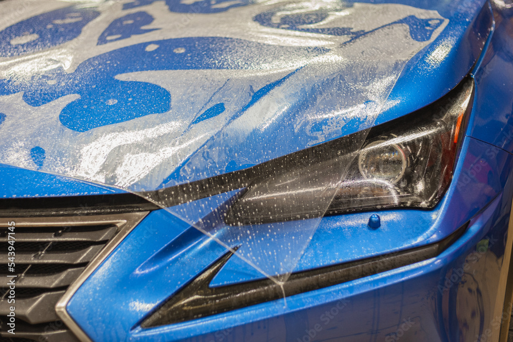 The process of installing PPF on the hood of the car.PPF is a ...