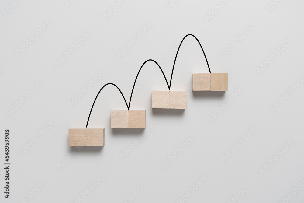 wooden blocks with the line as symbol of rise and increase on pastel ...