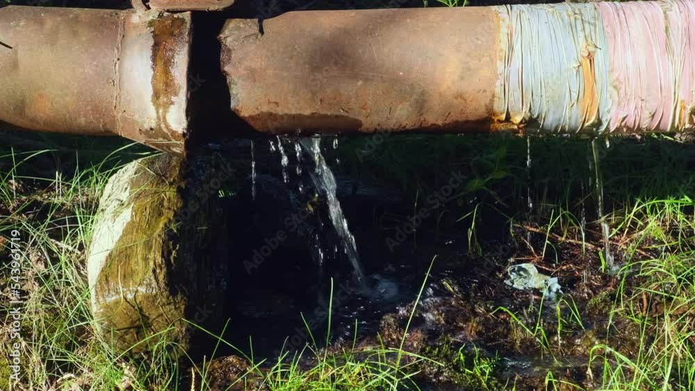 Water flowing from cracked pipe. Municipal accident, water leakage due ...