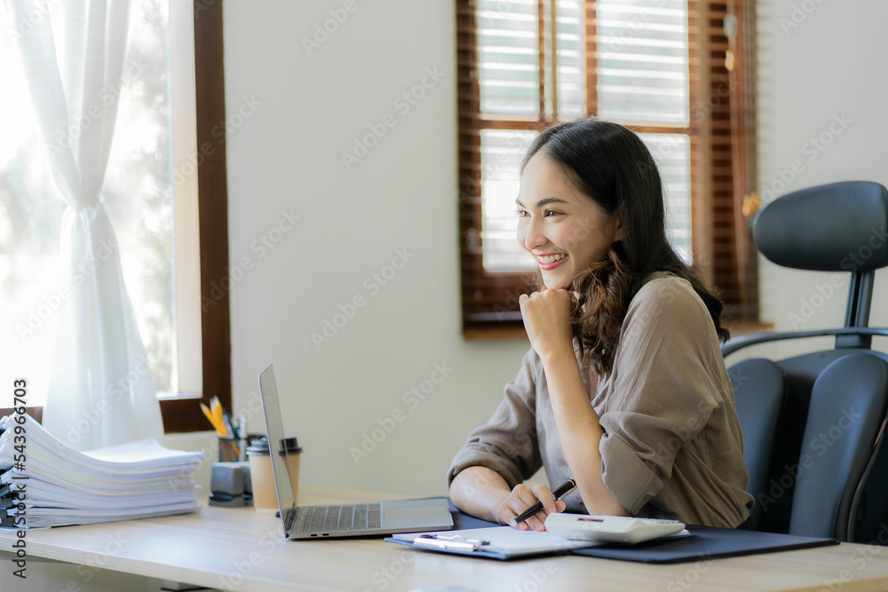 Asian female accountant working to analyze technical price charts and ...