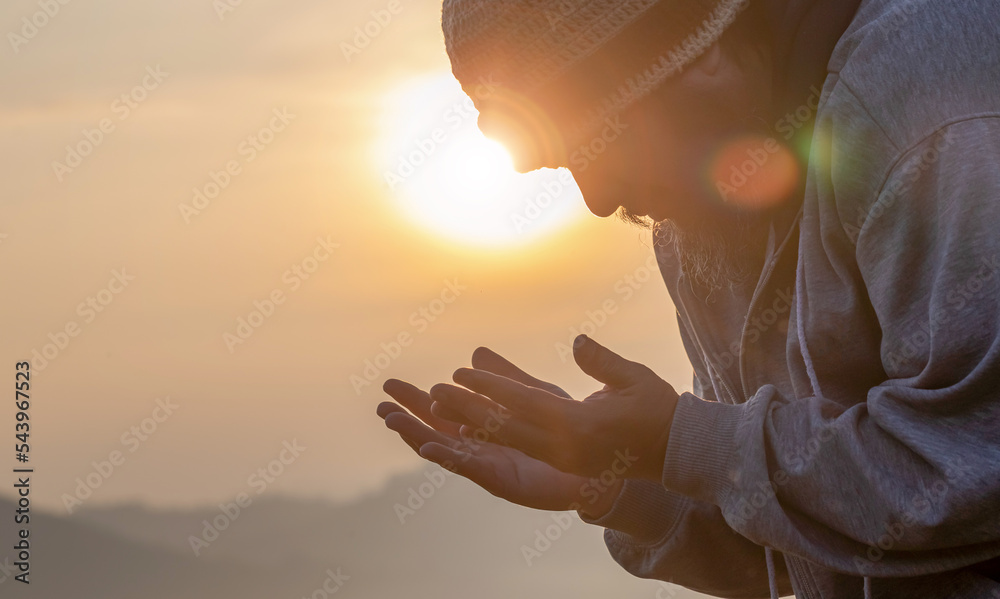 Human with hands open palm up praying to God on the mountain sunset ...