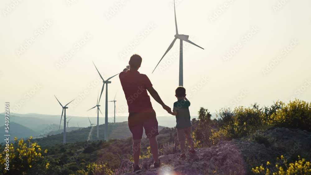 Stockvideon Dad and son look at the windmill farm. A man tells a child ...
