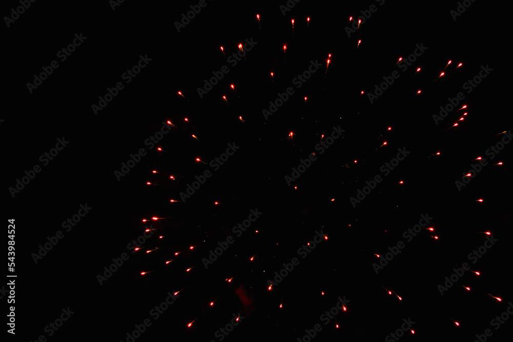 Sparkler firework with small white and red lights spreads radially over ...