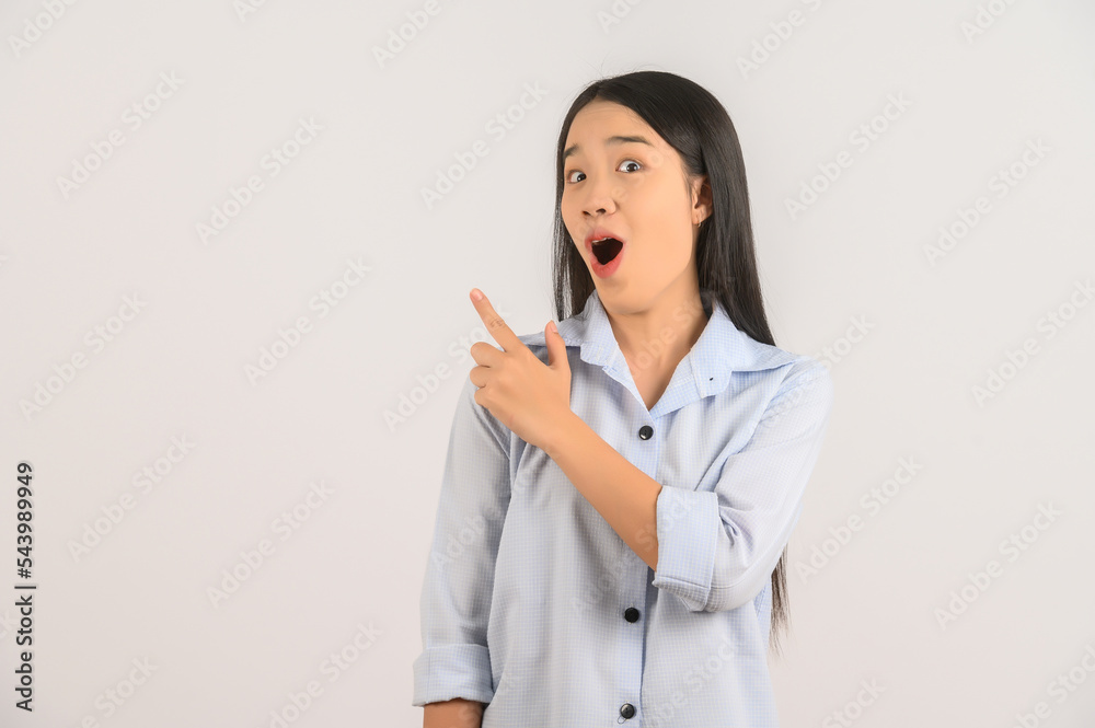 Portrait of young asian woman pointing with two hands and fingers to ...