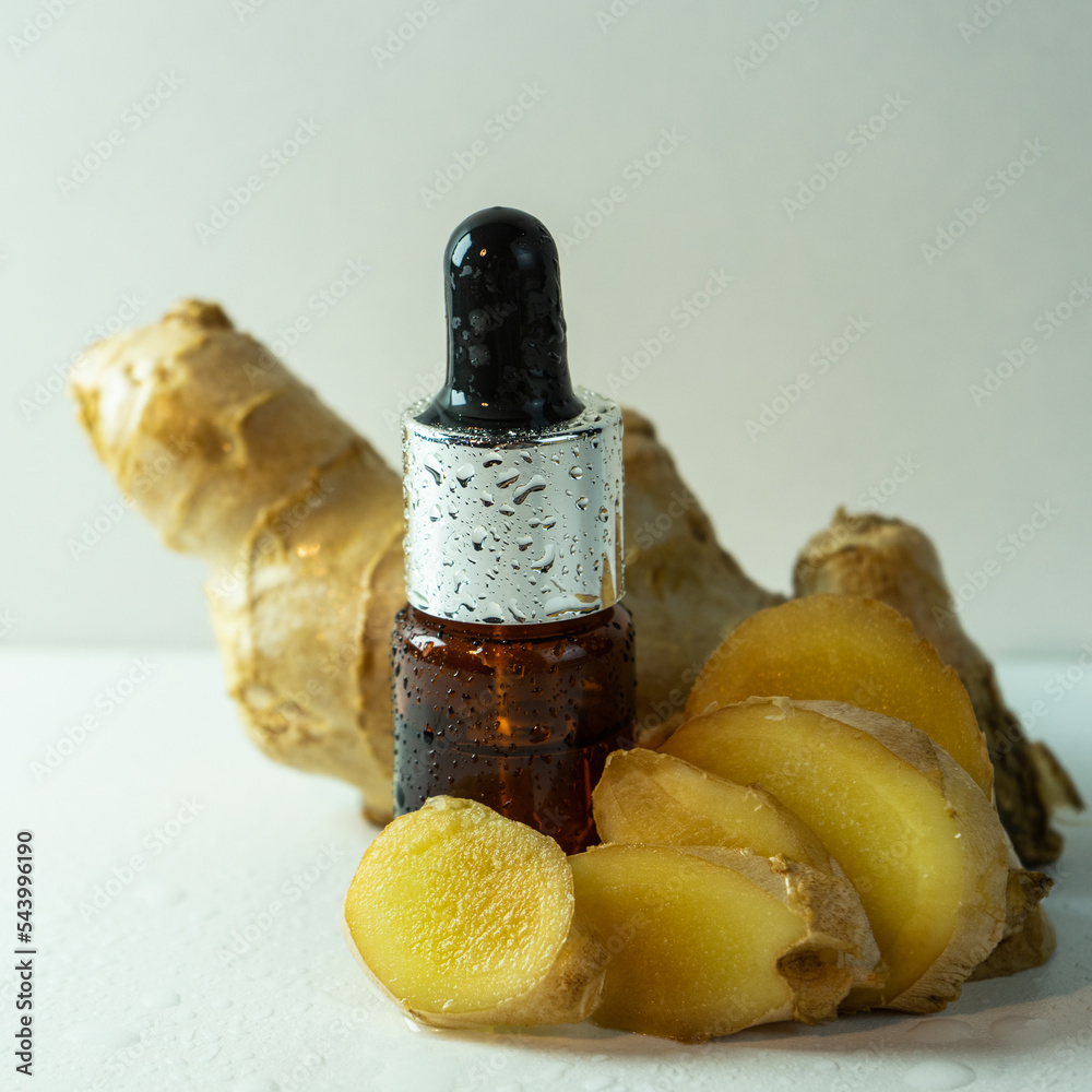 Amber glass dropper bottles and ginger root, natural cosmetics concepts ...