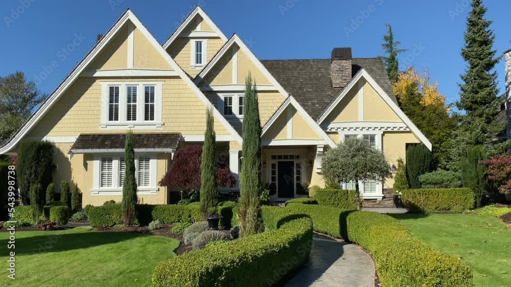 Establishing shot of two story stucco luxury house with garage door ...