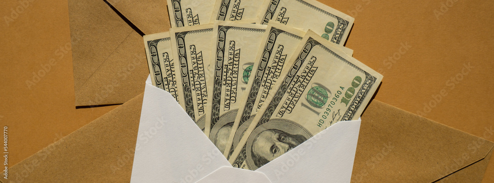 Dollar banknote saving money in envelope on beige background copy space ...