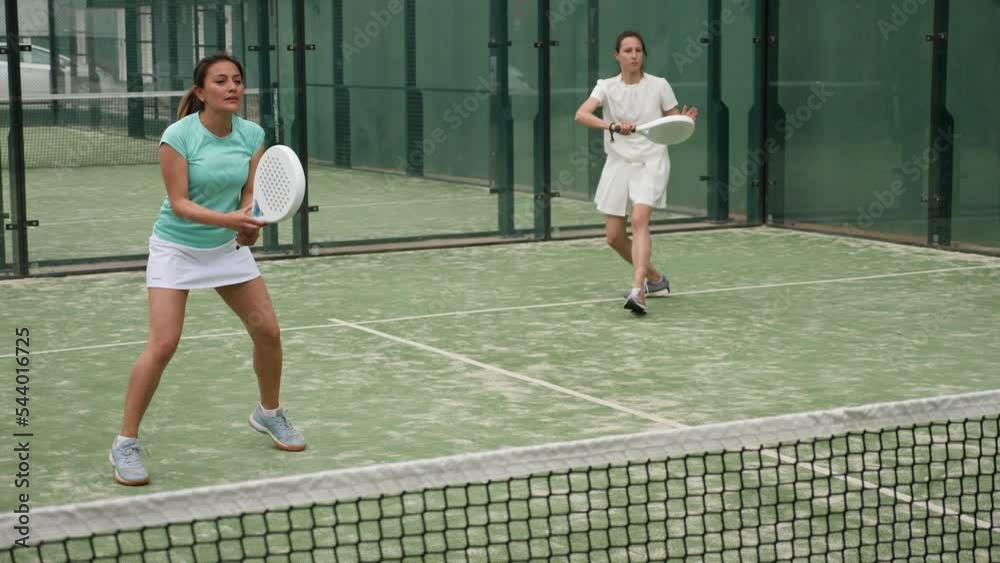 Female paddle tennis player during couple match at court. High quality ...