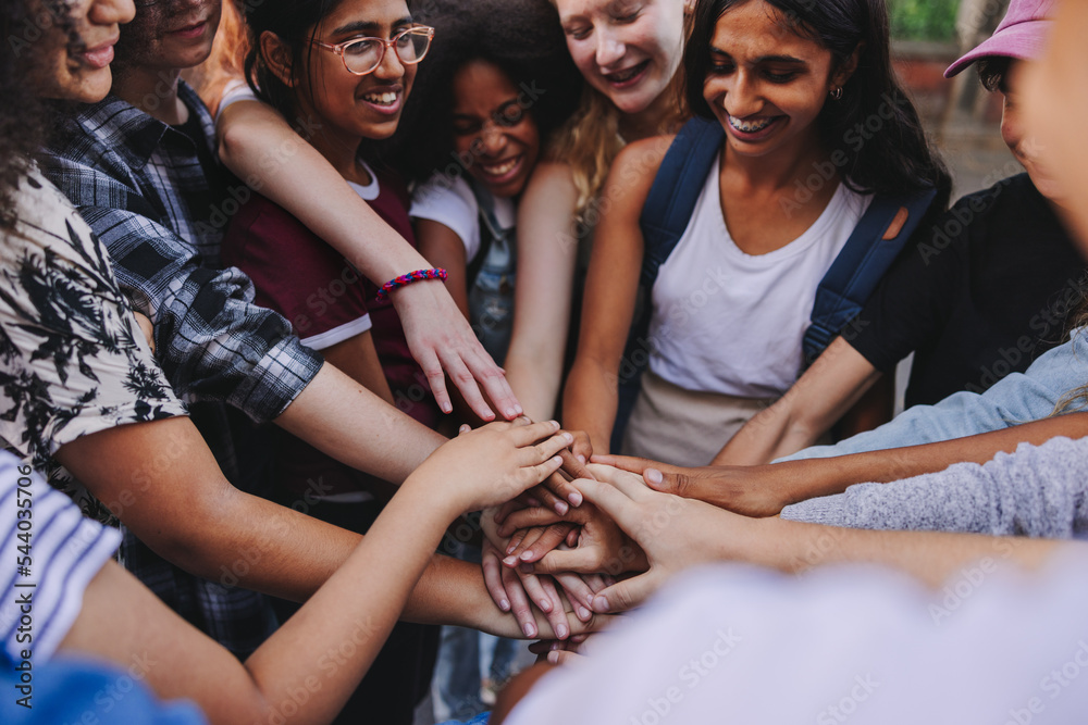 Happy teenagers putting their hands together in a huddle Stock Photo ...