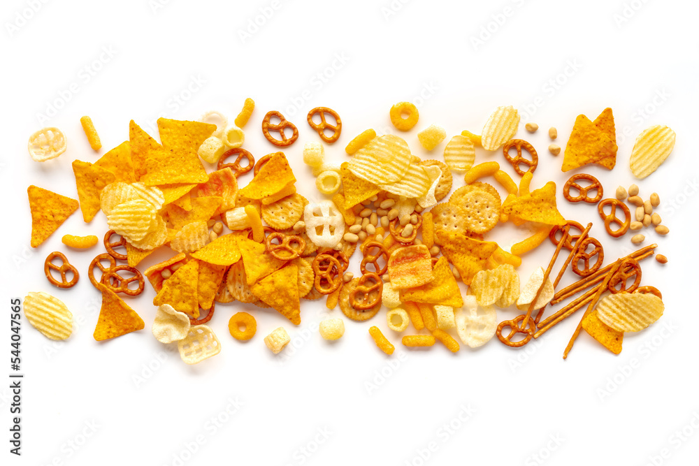 Salty snacks texture on a white background. Party food mix. Potato and ...
