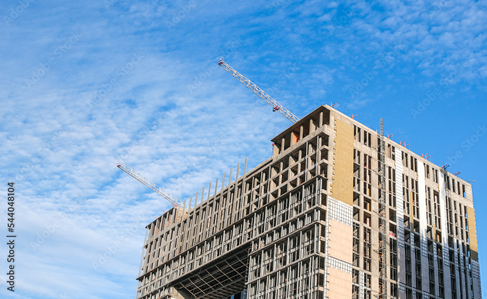 Construction site. Construction cranes and a building under ...
