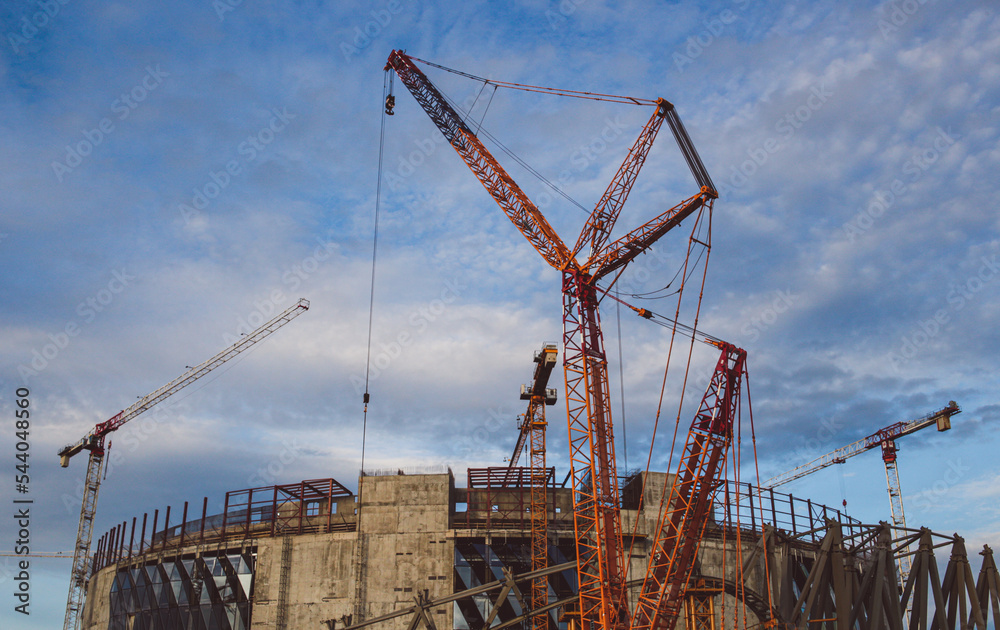 Construction site. Construction cranes and a building under ...
