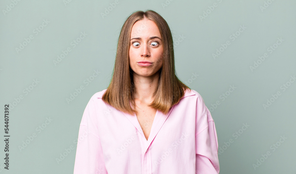 looking goofy and funny with a silly cross-eyed expression, joking and ...