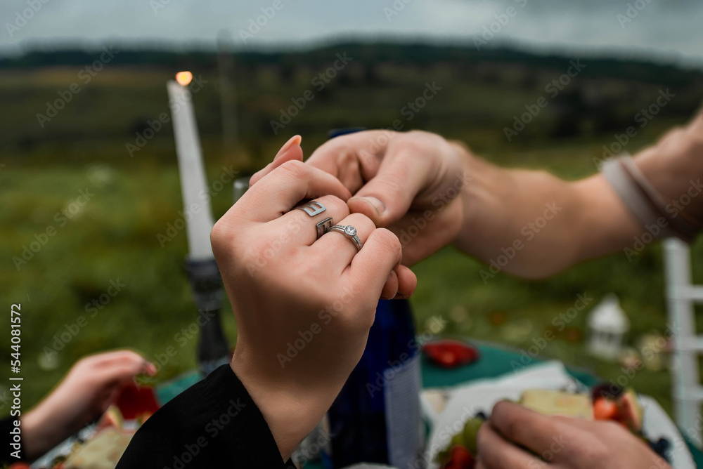 The newlyweds are holding hands. Engagement ceremony. She said yes. A ...