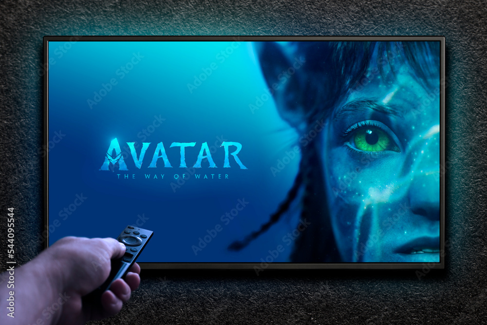 Man turns on TV with remote control. TV screen playing Avatar the way ...