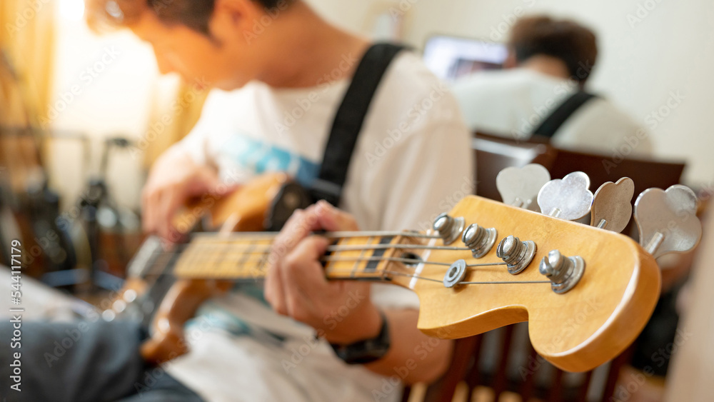 Bass guitar player or Bassist hand playing electric bass guitar in ...