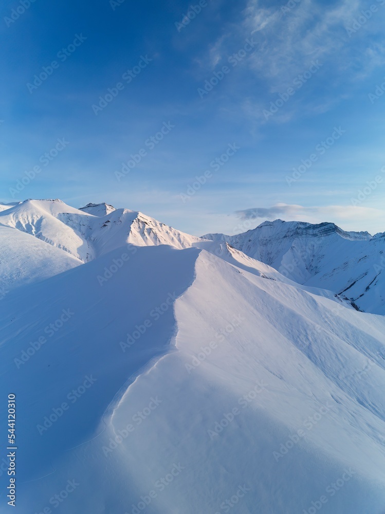 Aerial of snowy mountain slopes full of powder for freeride at ski ...