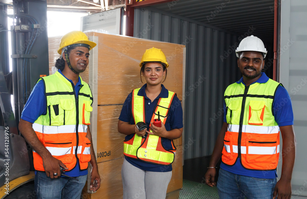 Indian male and female workers use a forklift Loading packaging boxes ...