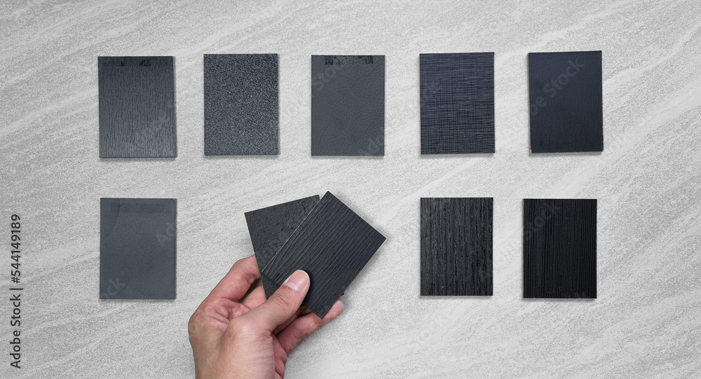 architect's hand holding some samples of melamine. palette of mdf wood ...