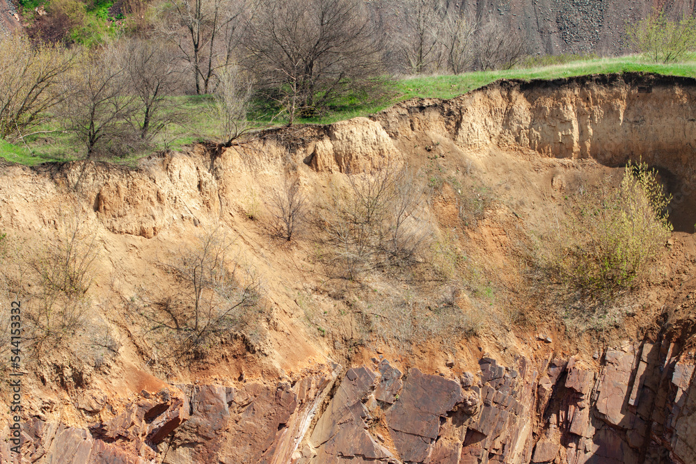 Soil erosion, sliding, and caving. Inside the landslide is rock ...