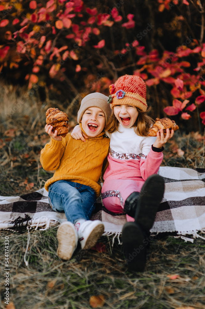 A fashionable boy of preschool age and his friend a smiling girl laugh ...