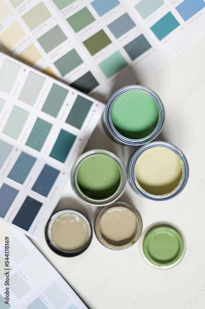 Tiny sample paint cans during house renovation, process of choosing ...