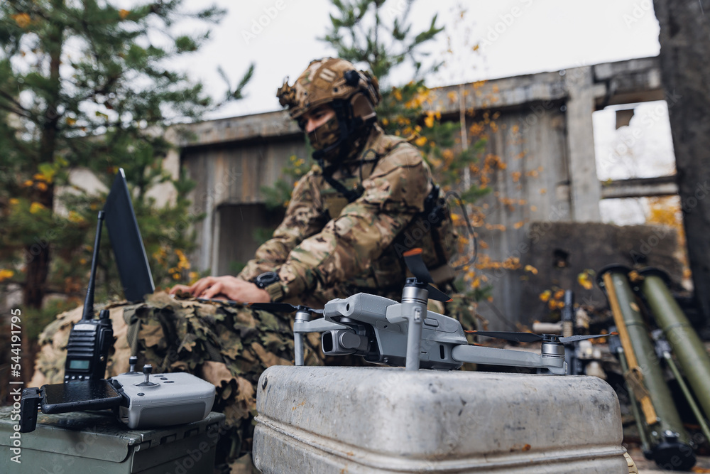 Modern army soldiers using aerial drone for artillery guidance and ...